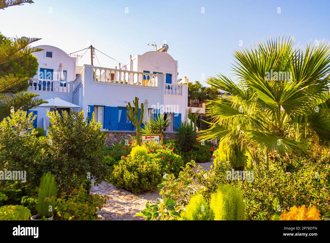 Pretty traditional house with beautiful flowering shrubs in front in ...