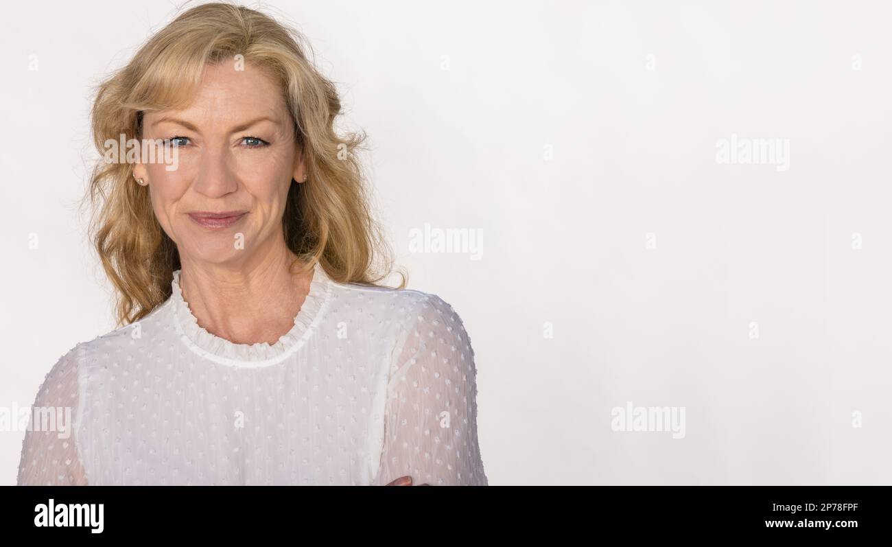 Attractive happy smiling female middle aged woman studio portrait on a white background Stock ...