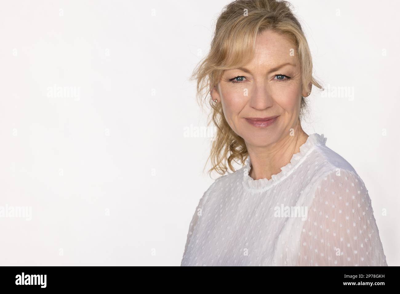 Attractive happy smiling female middle aged woman studio portrait on a white background Stock ...