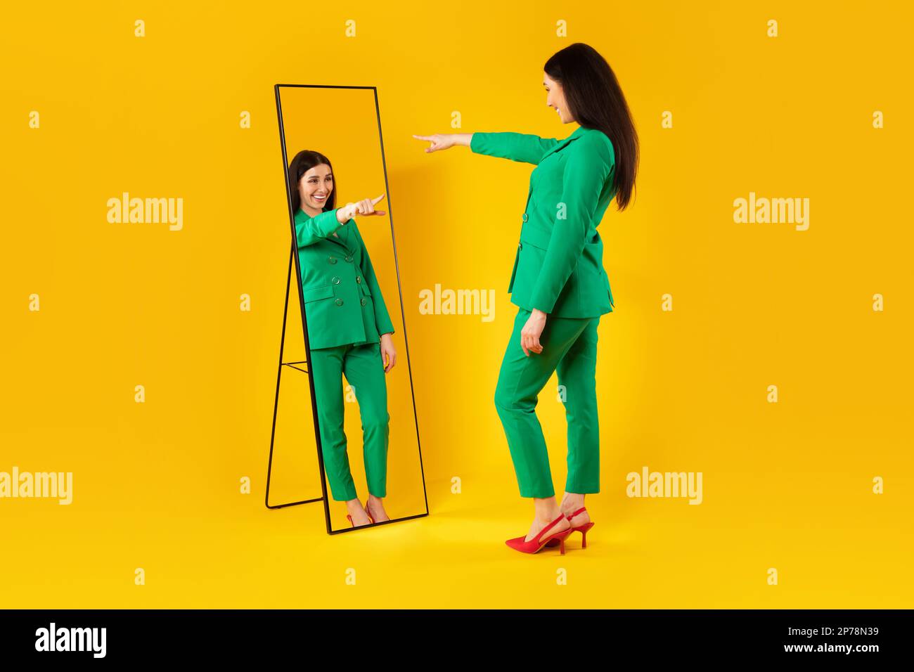 I choose myself. Excited stylish lady pointing finger at her reflection ...