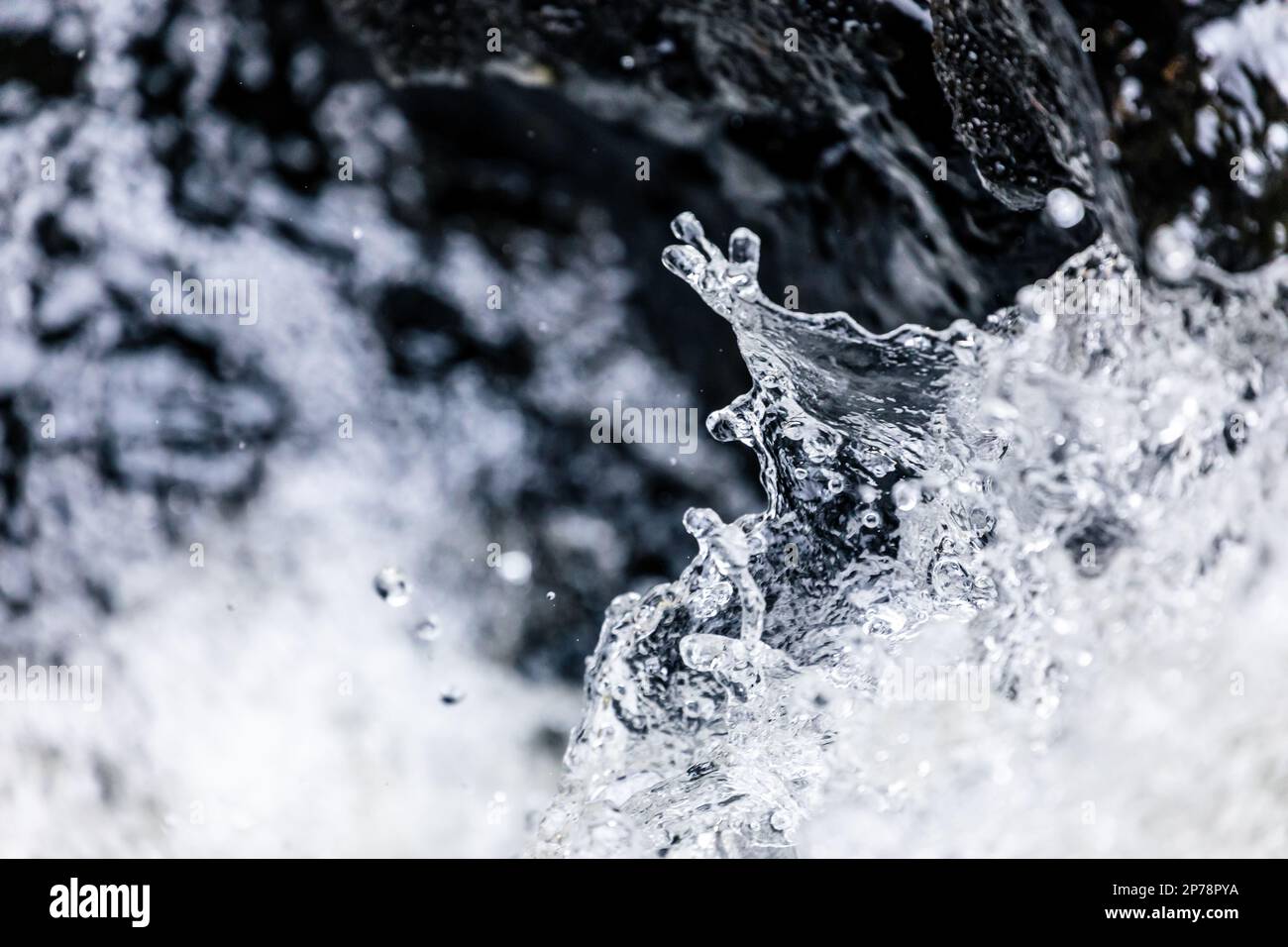 Close focus on body of splashing water of fast flowing stream in river ...
