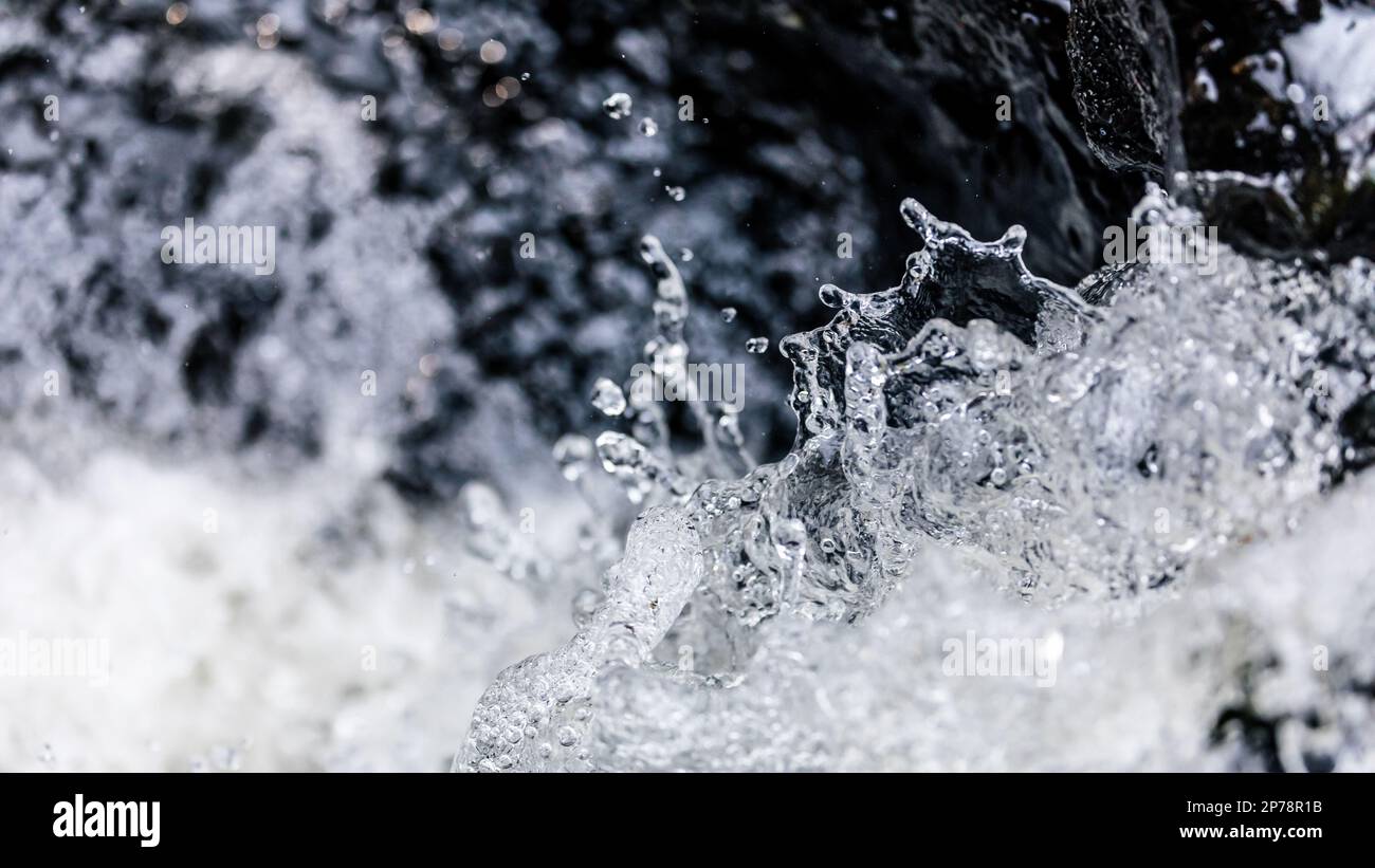 Close focus on body of splashing water of fast flowing stream in river ...