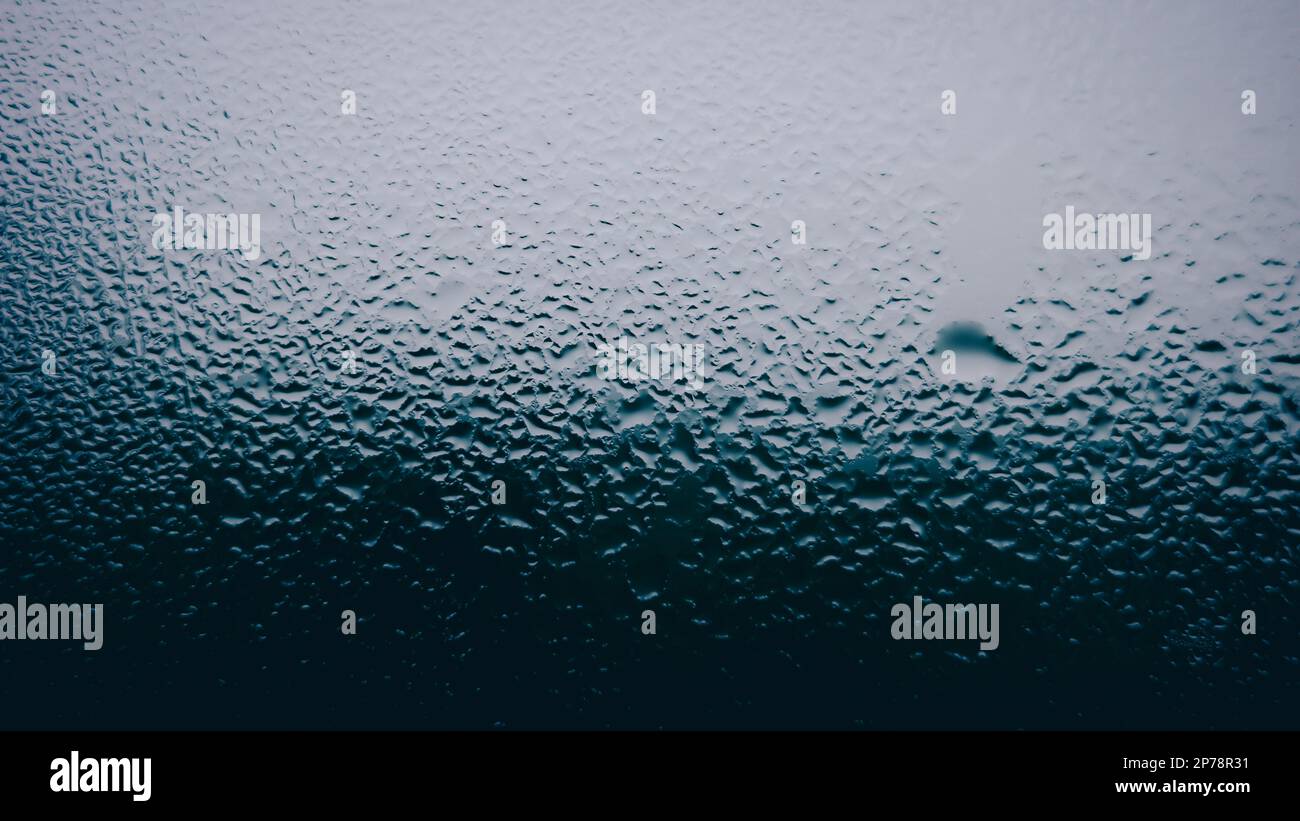 Waterdrops on glass window after raining with bright light from ...