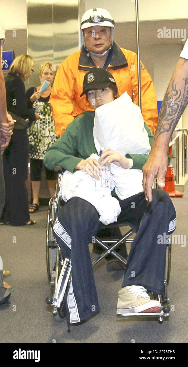 Kento Okuda, is taken to a boarding gate at Christchurch Airport, New ...