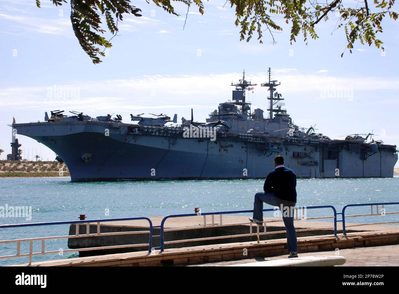 An Egyptian watches US amphibious assault ships USS Kearsarge as it ...