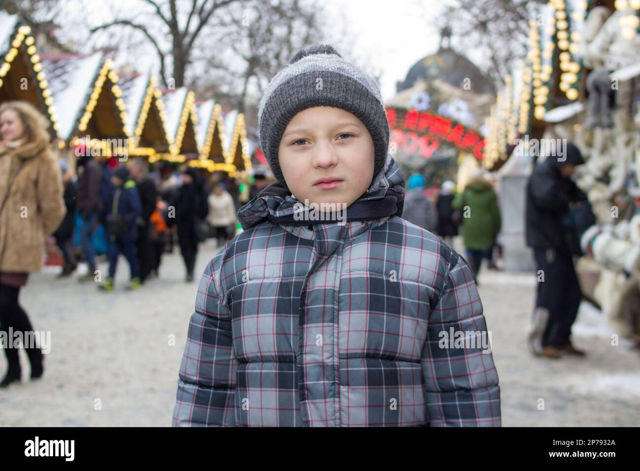 One boy at the winter fair in the square Stock Photo - Alamy