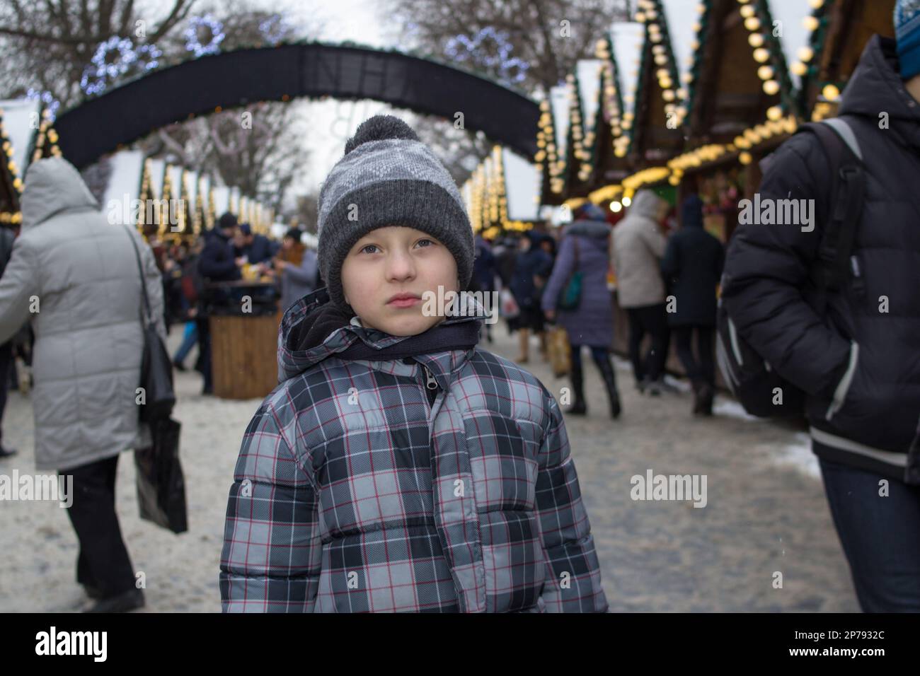 a sad boy stood at the Christmas fair itself Stock Photo - Alamy