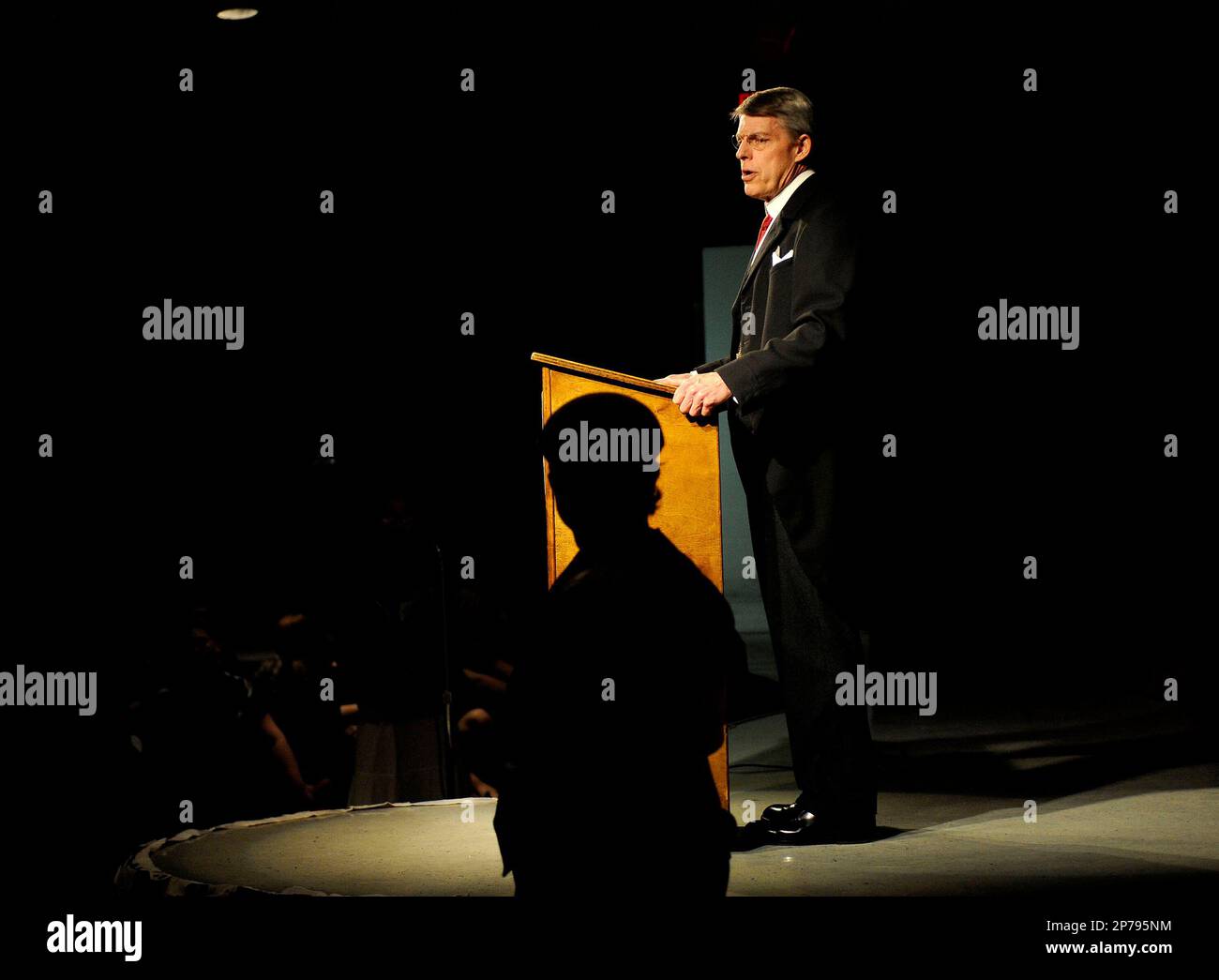Press secretary Cole Fainter is silhouetted against the podium where ...