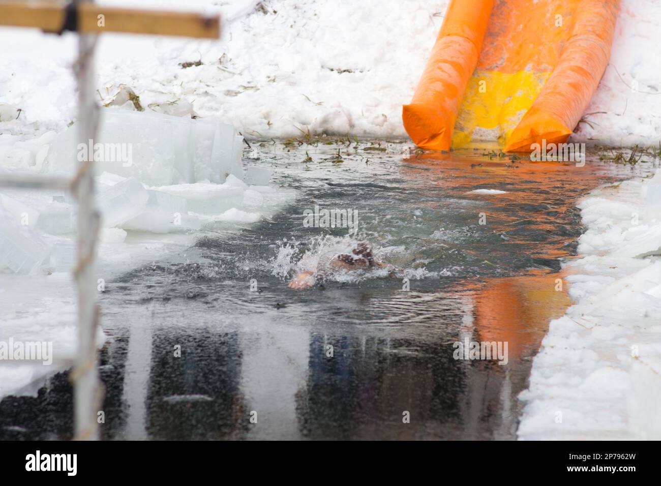 tempered people floating in the water in winter Stock Photo - Alamy