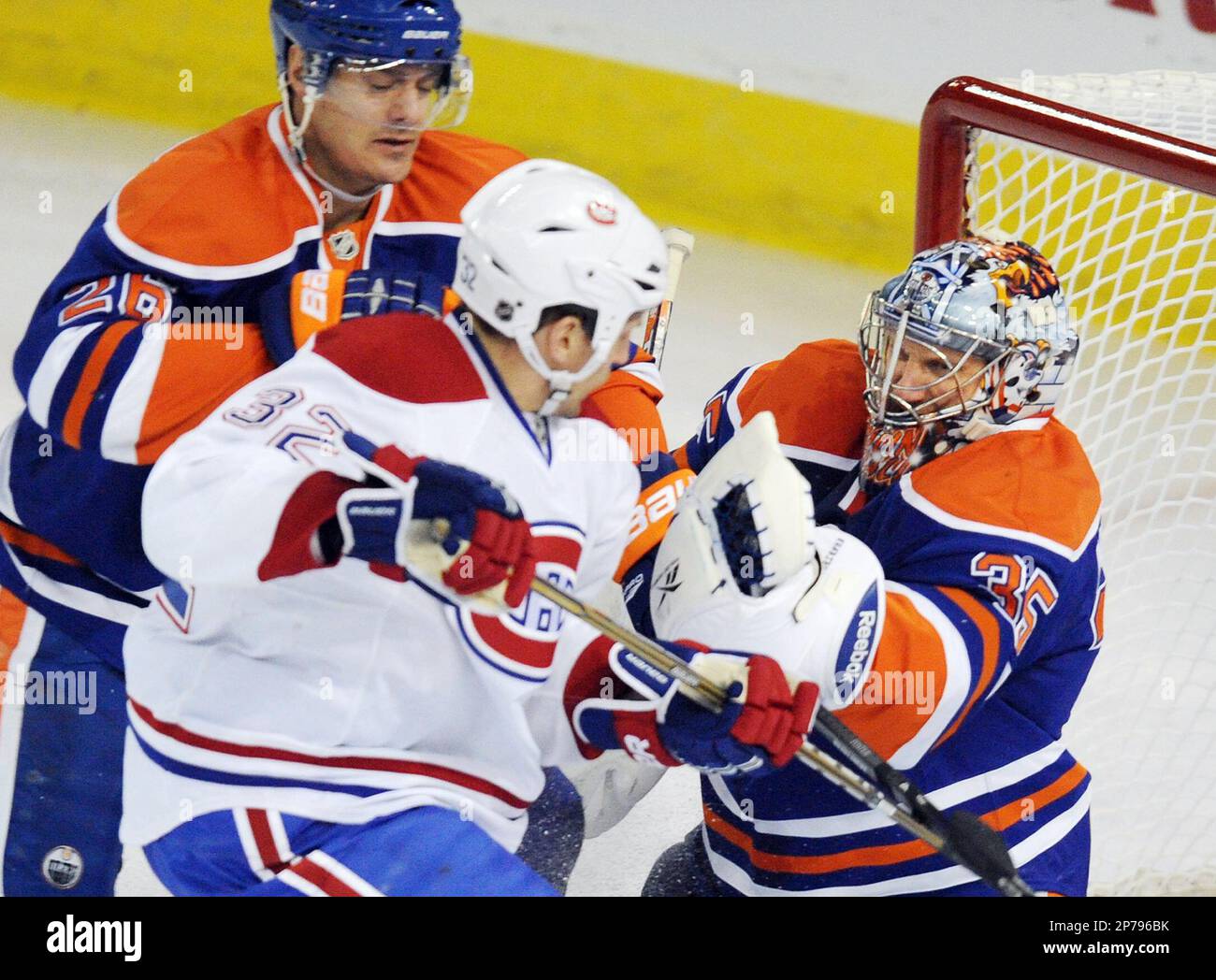 Edmonton Oilers' Kurtis Foster, left, defends goalie Nikolai Khabibulin ...