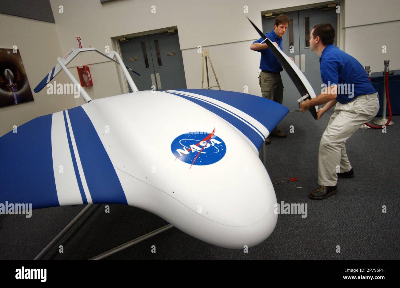 Liam Flanigan, left, and L.C. Lede', front right, remove the left wing ...