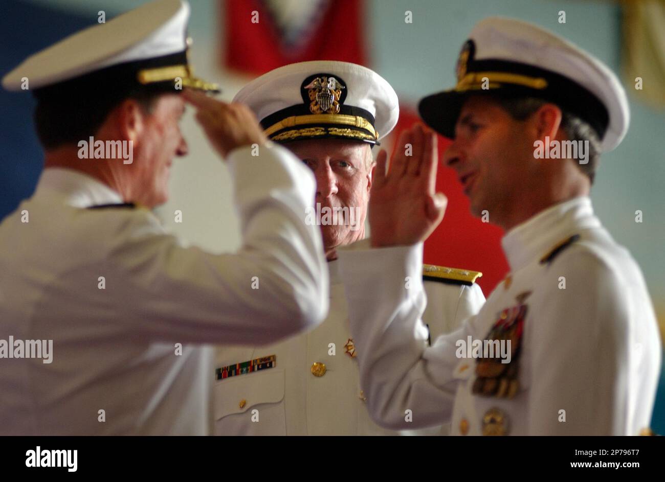 Rear Admiral Michael D. Malone, center, watches as Rear Admiral James M ...