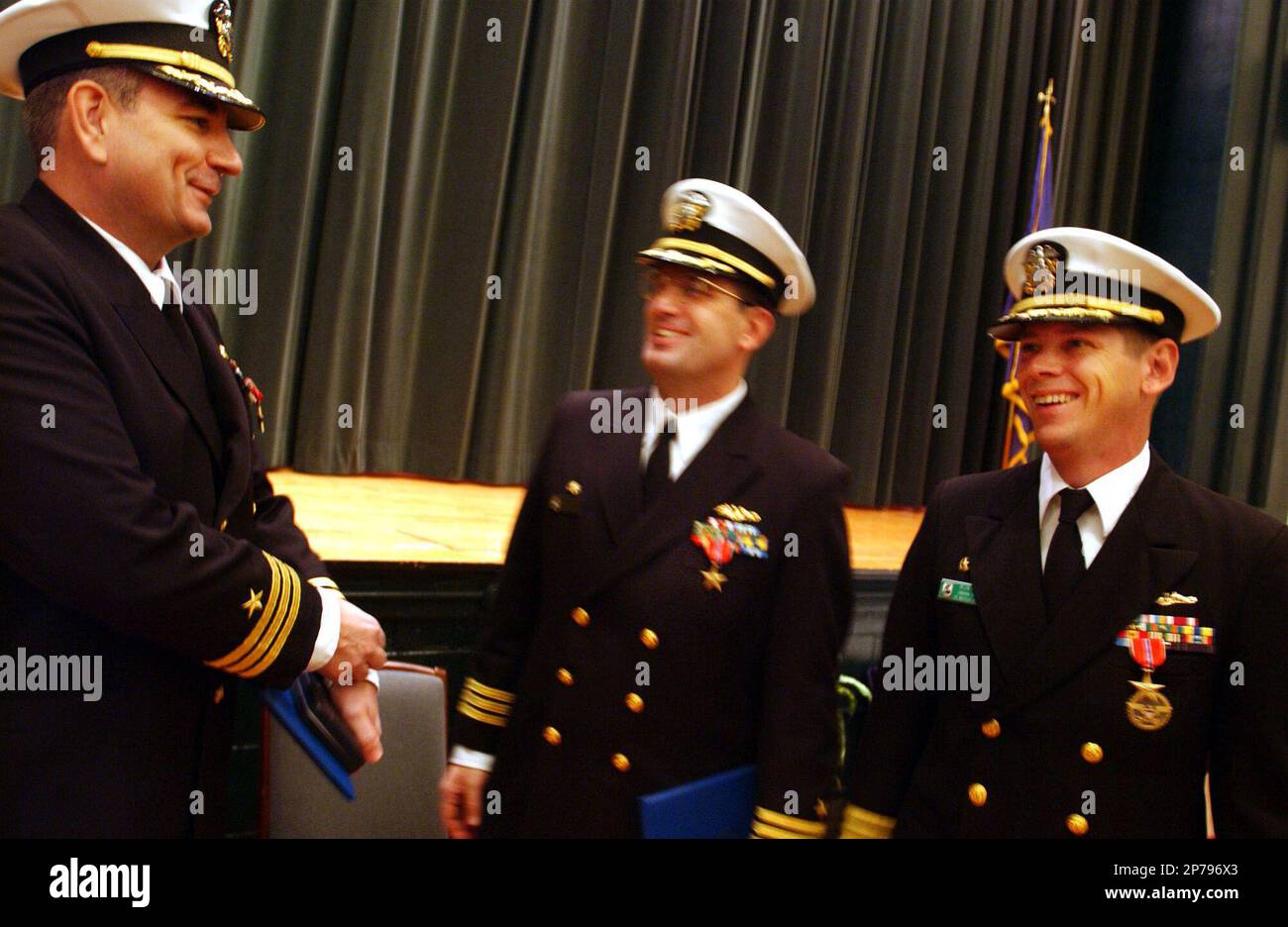 From left to right, Cmdr. JIm Kuzma, former commanding officer of the ...