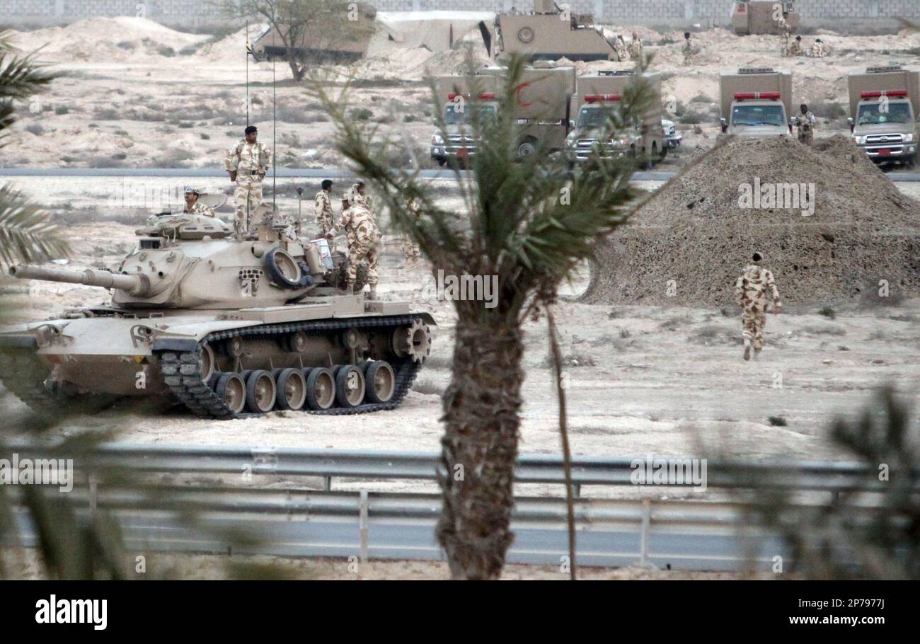 Bahraini soldiers in tanks and armored vehicles stand ready Thursday ...