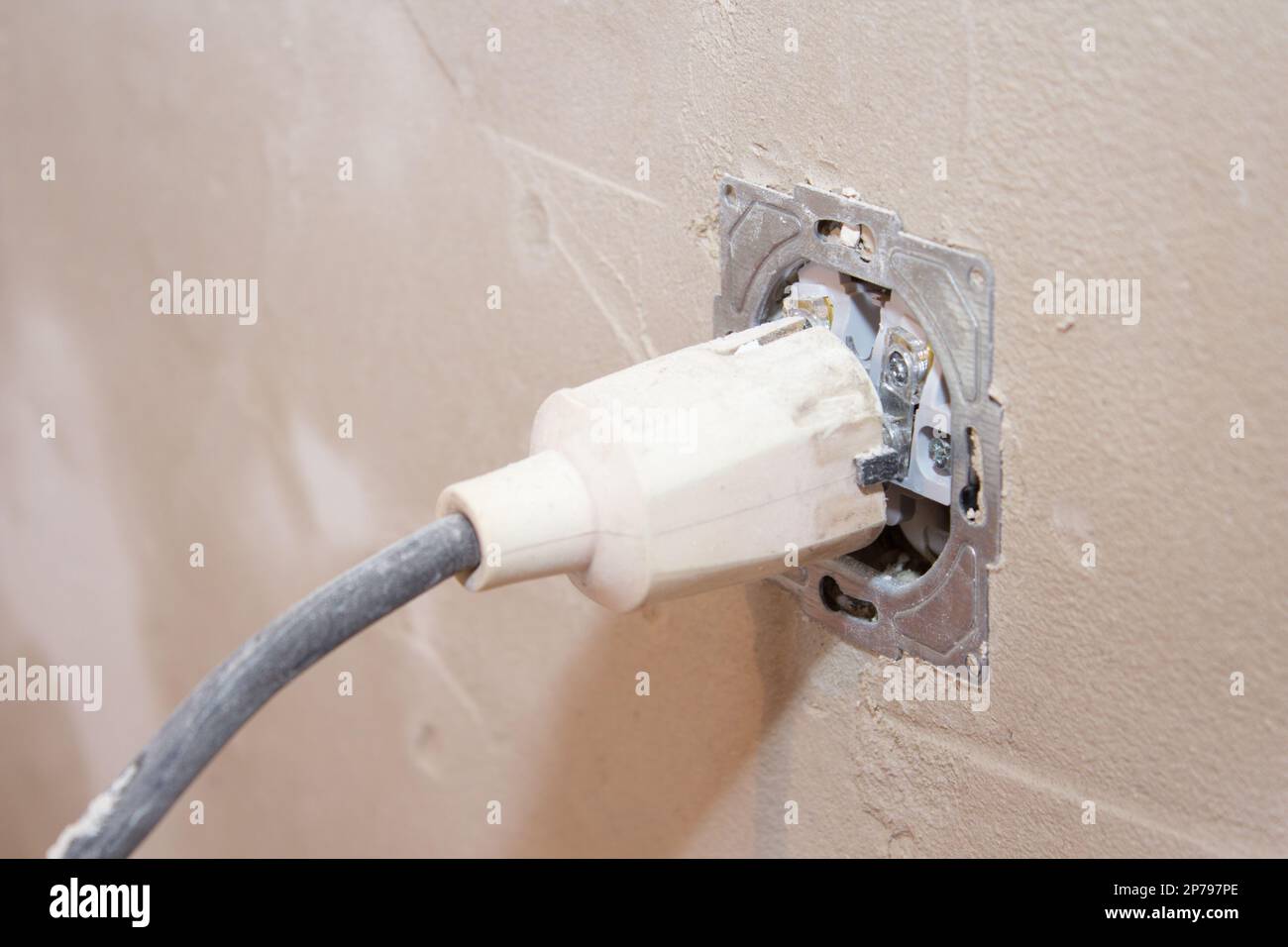 Plug in the socket without the cover is turned on Stock Photo - Alamy