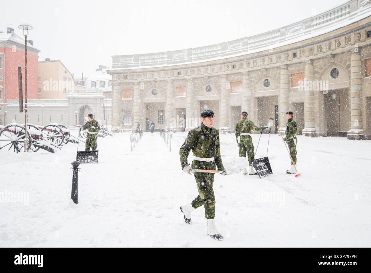 Soldiers clear snow outside the Royal Palace in Stockholm, Sweden, on ...