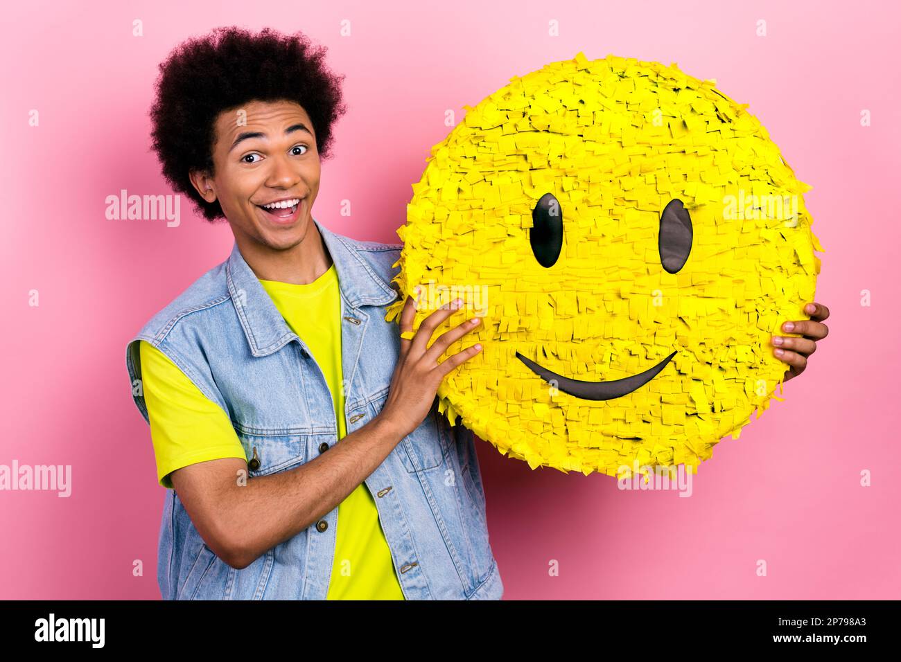 Portrait of excited funky guy hands hold large emoji smiley collage ...
