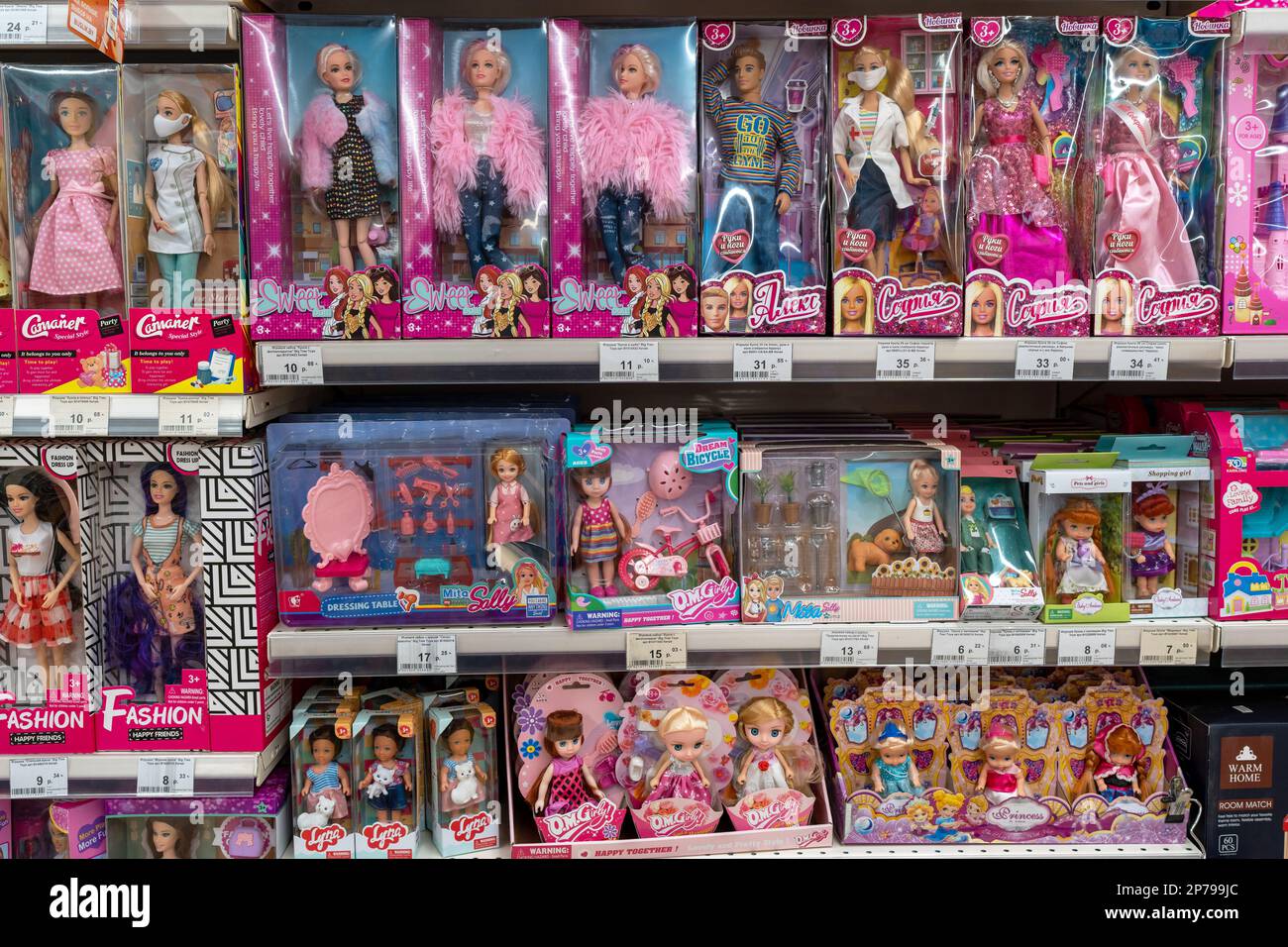 Shelves with dolls for children in a toy store. Large selection of ...