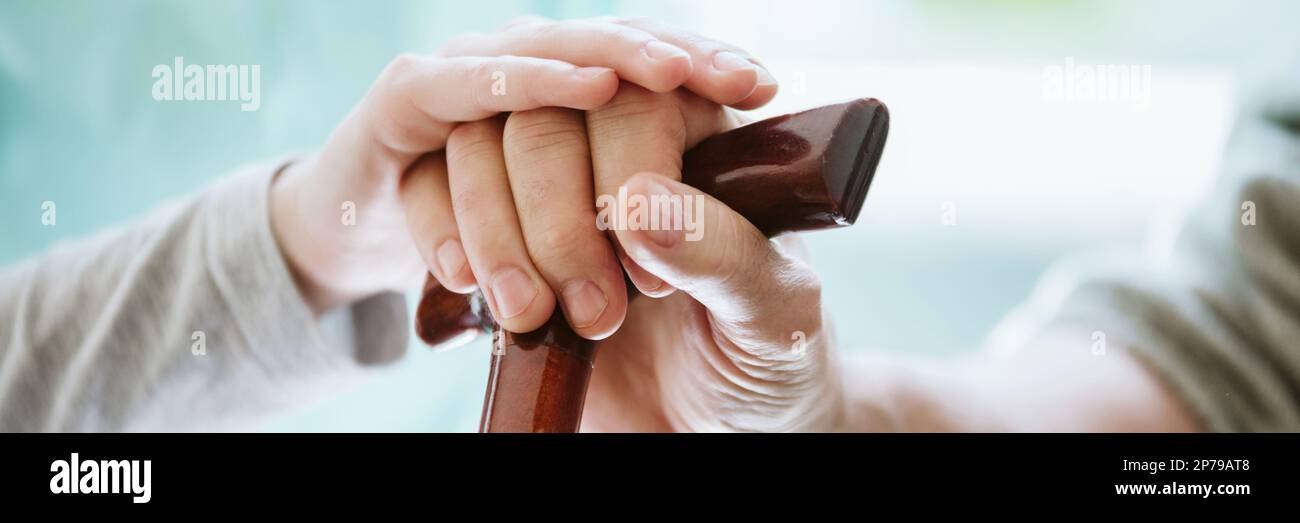 Symbolic photo with two hands - young helping elder one Stock Photo - Alamy