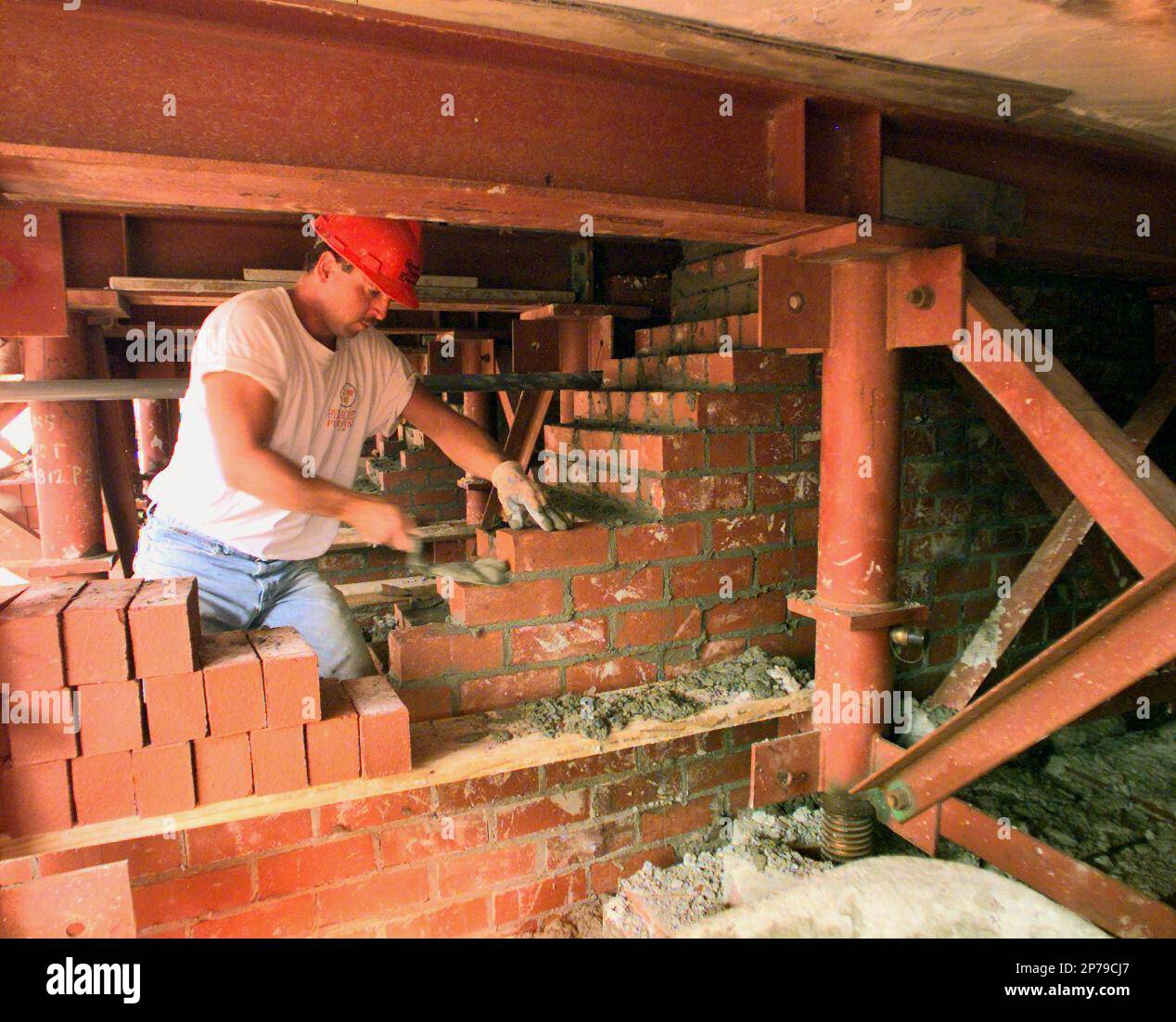 Robert Hardee, 37, of Virginia Beach, lays bricks in the new foundation ...