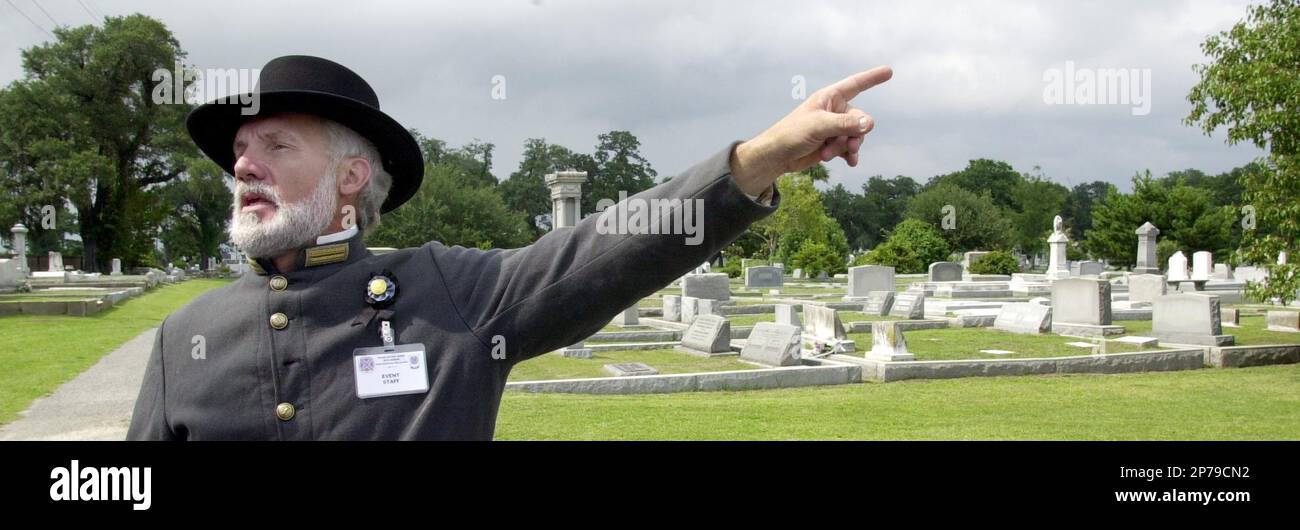 A Confederate re-enactor volunteer directs guest to the grave of the ...