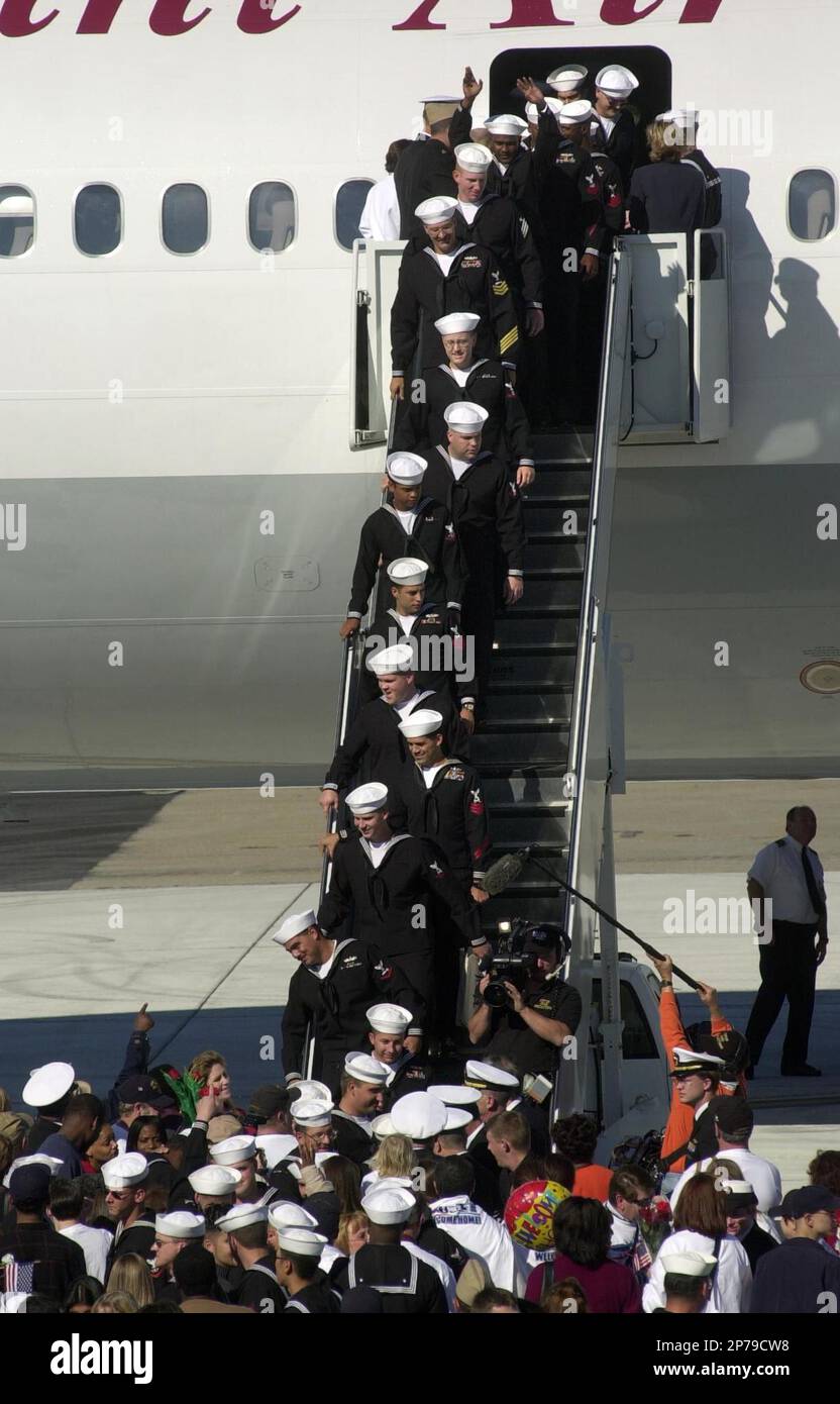 The crew of the USS Cole getting off a commercial DC10 airplane upon ...