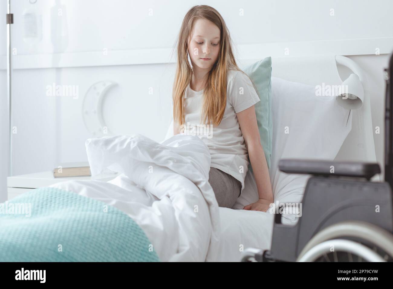 Young sick girl trying to stand up from hospital bed Stock Photo - Alamy