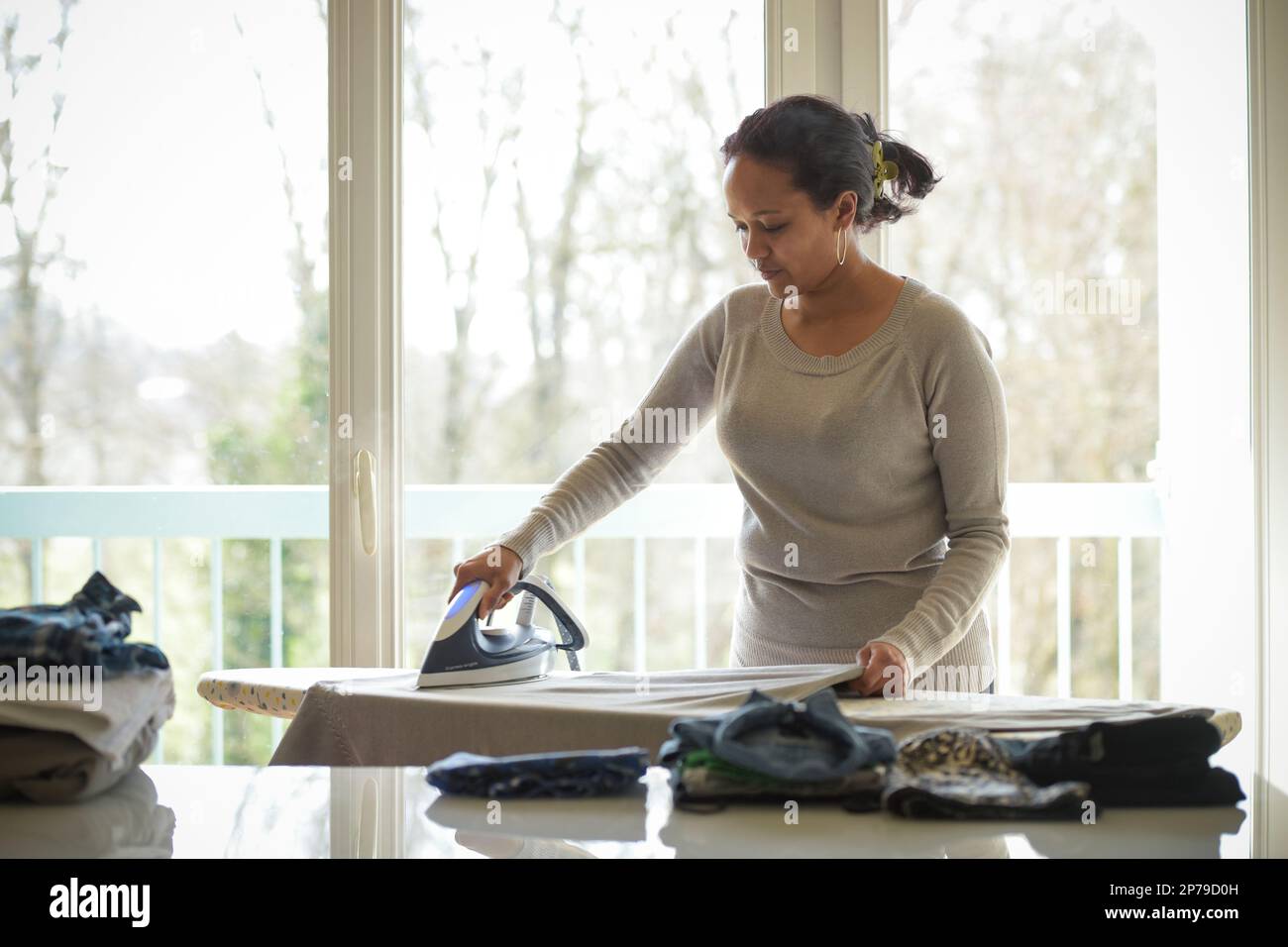 Woman ironing at home hi-res stock photography and images - Alamy