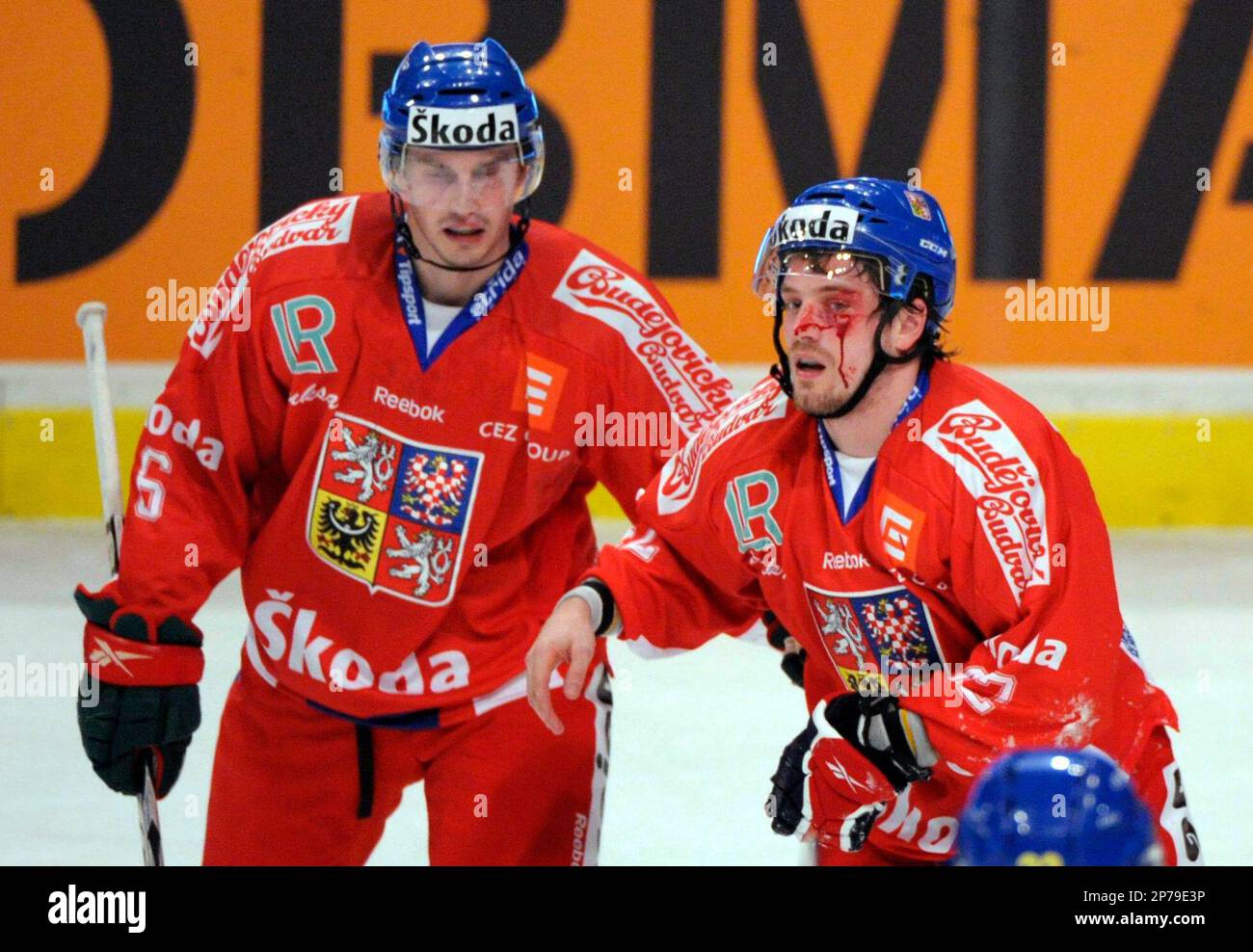 Czech Republic's Petr Koukal, right, is helped off the ice by teammate ...
