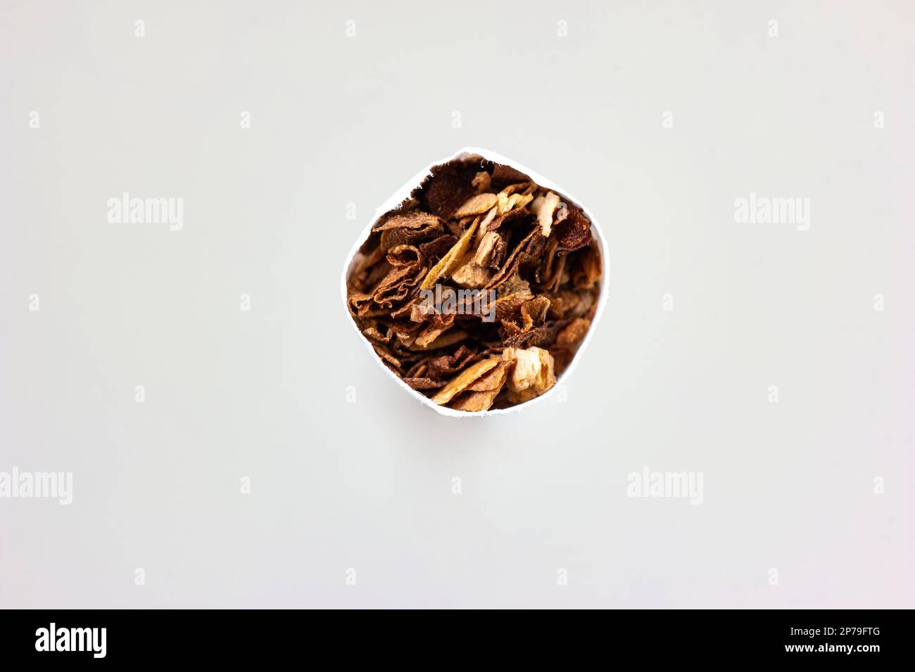 Single unlit cigarette stick macro detail shot of ground tobacco leafs ...