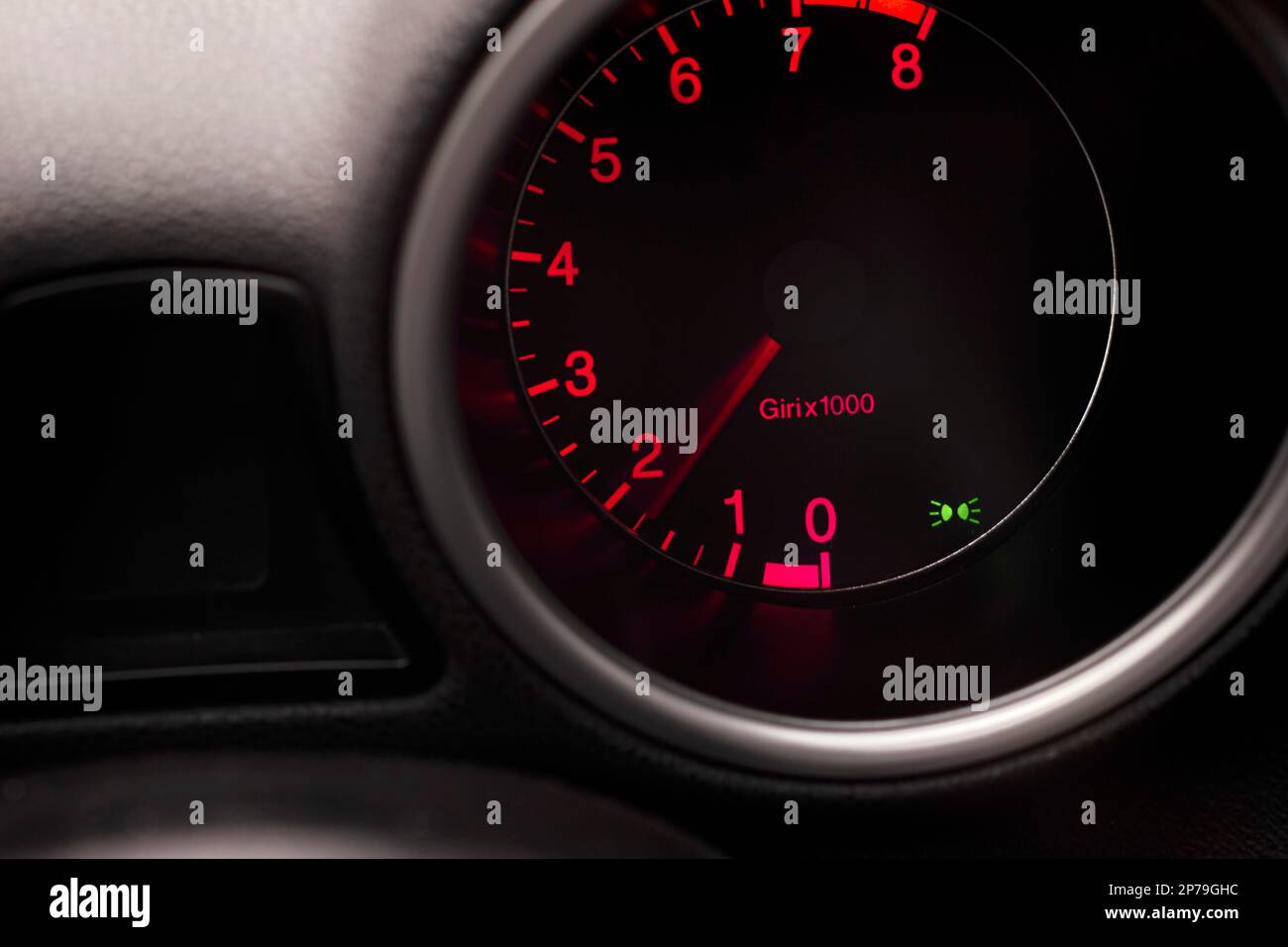 Car dashboard tachometer rev counter with red background lighting and ...