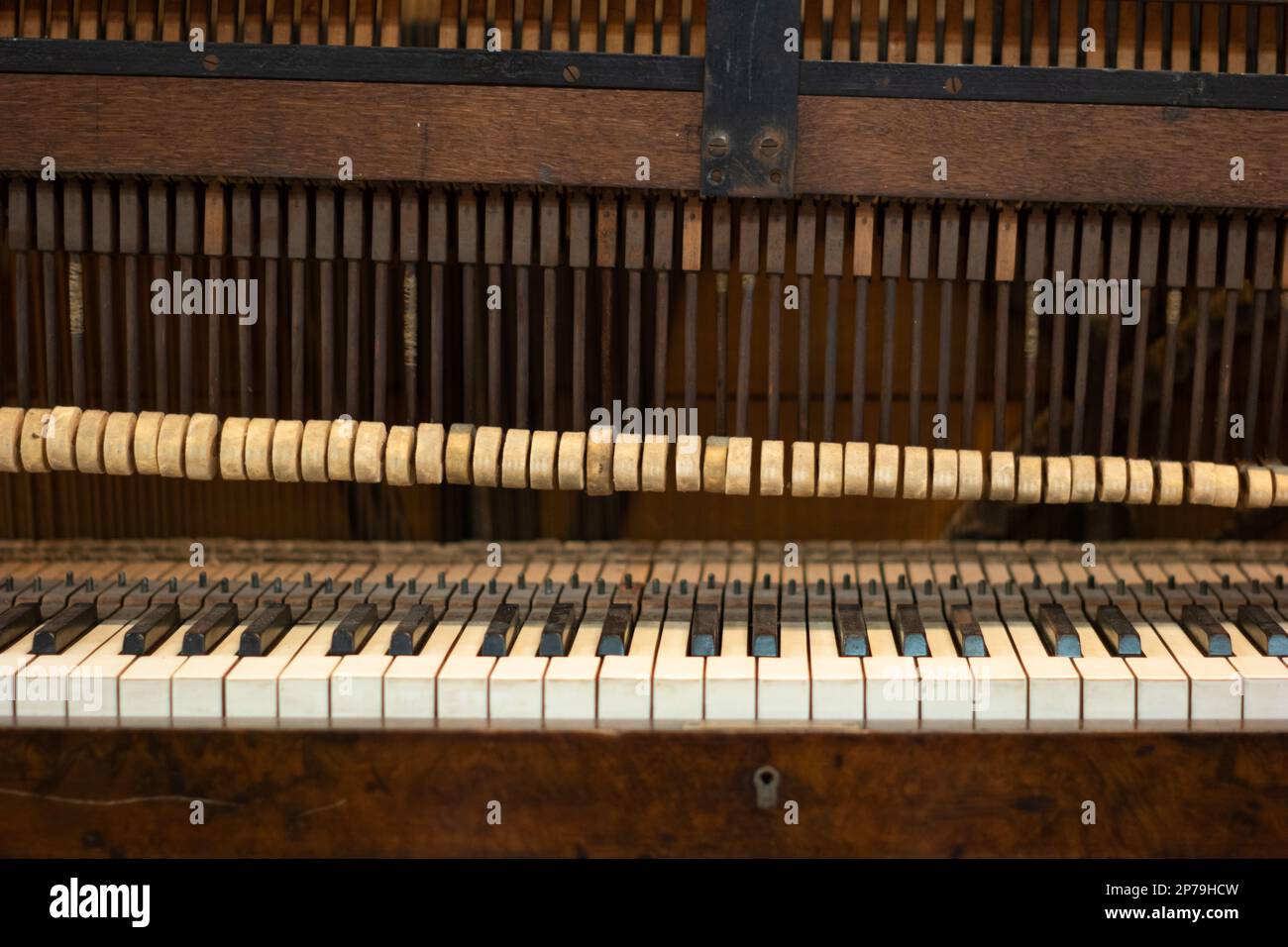 Old broken unplayable piano exposed parts dilapidated state front view ...