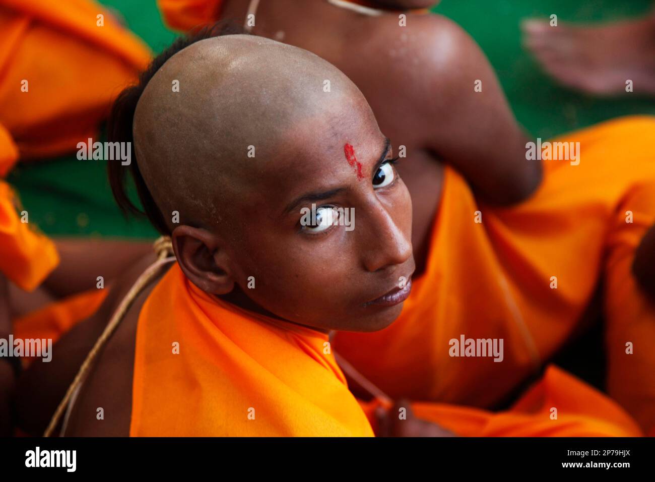 A Hindu boy looks on as he listens to the Guru, unseen, during the ...