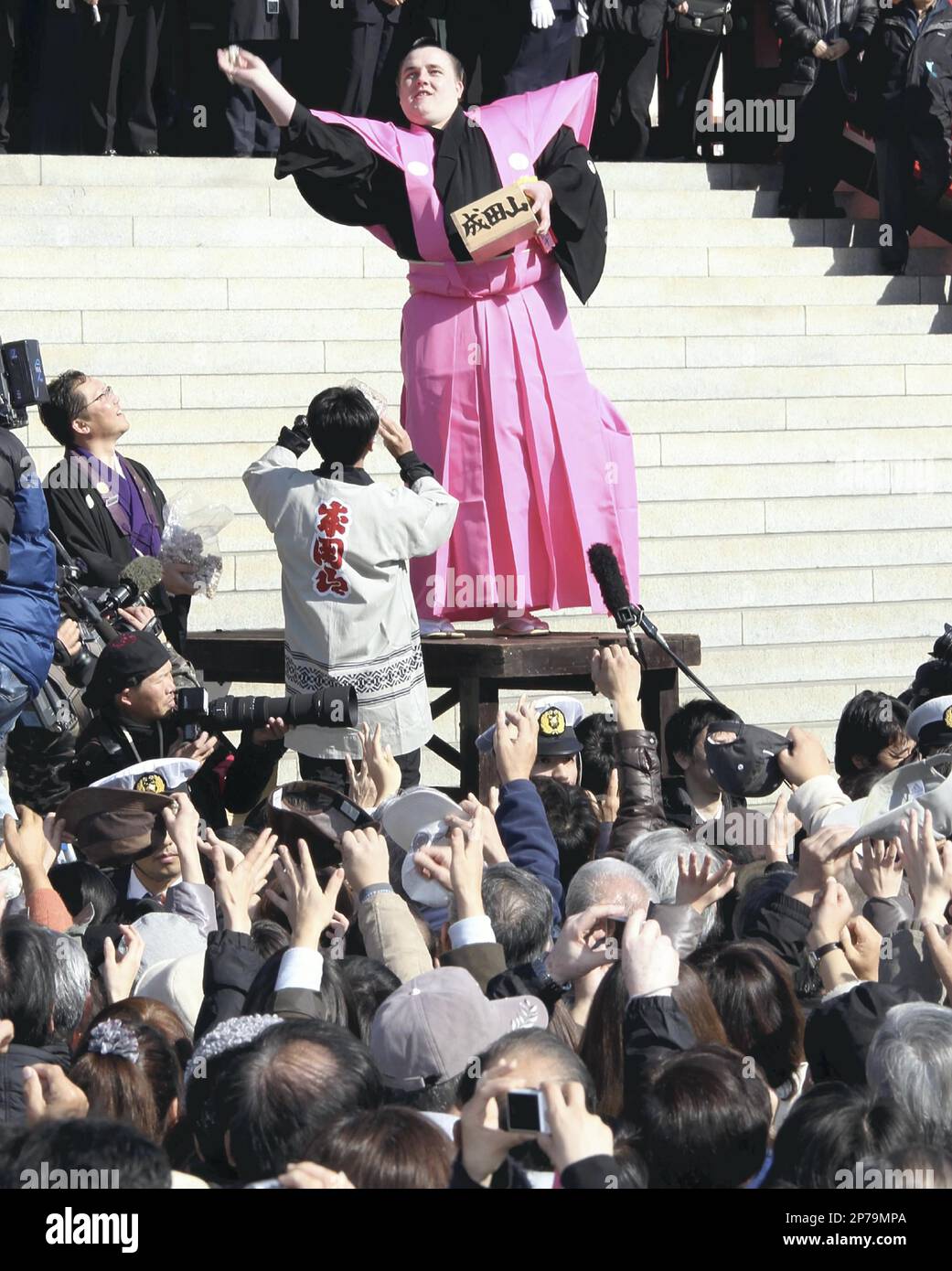 Estonian sumo wrestler Baruto tosses soy beans from above to a crowd of ...