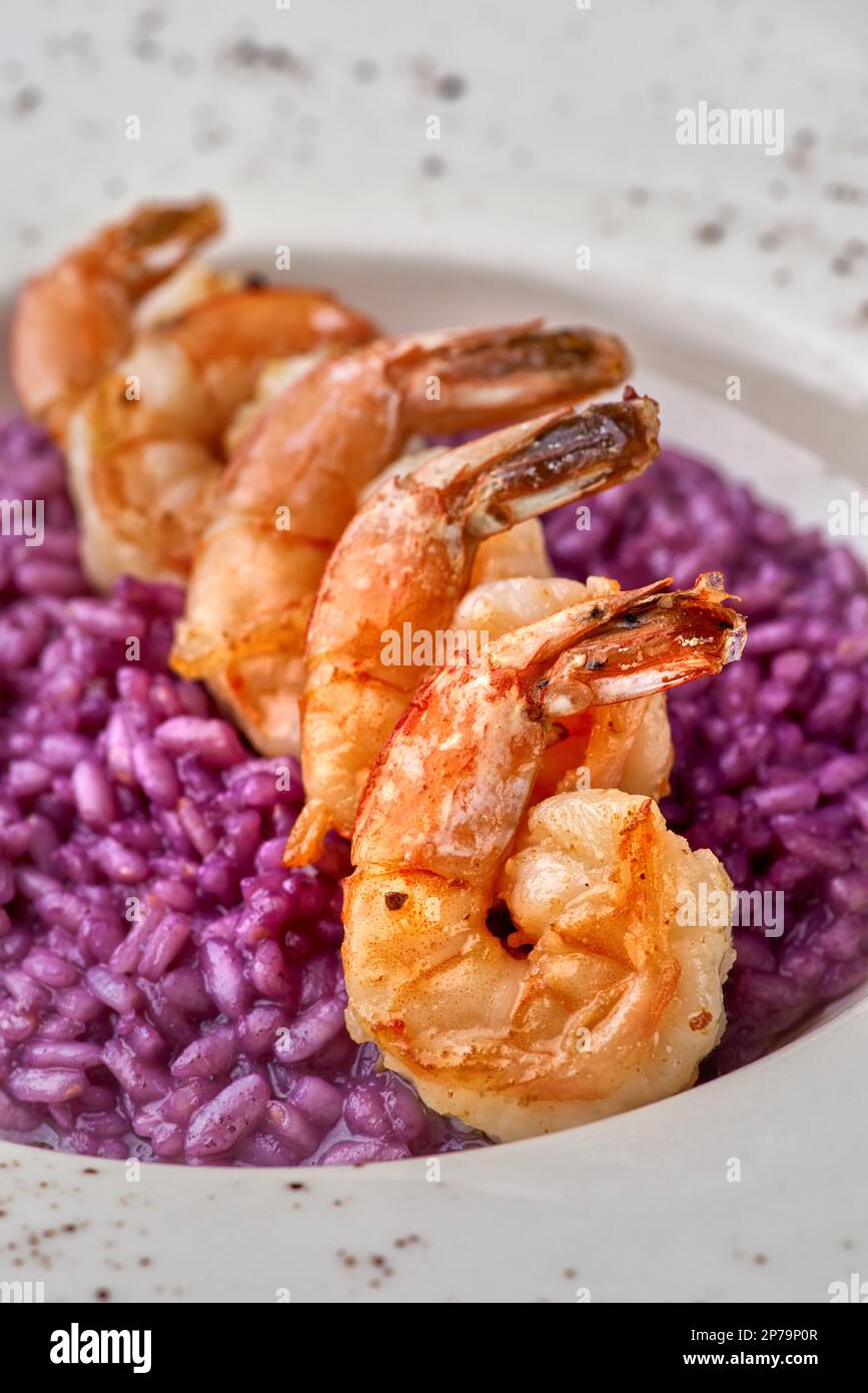 Delicious Italian risotto with grilled big tails of shrimp. Pink ...