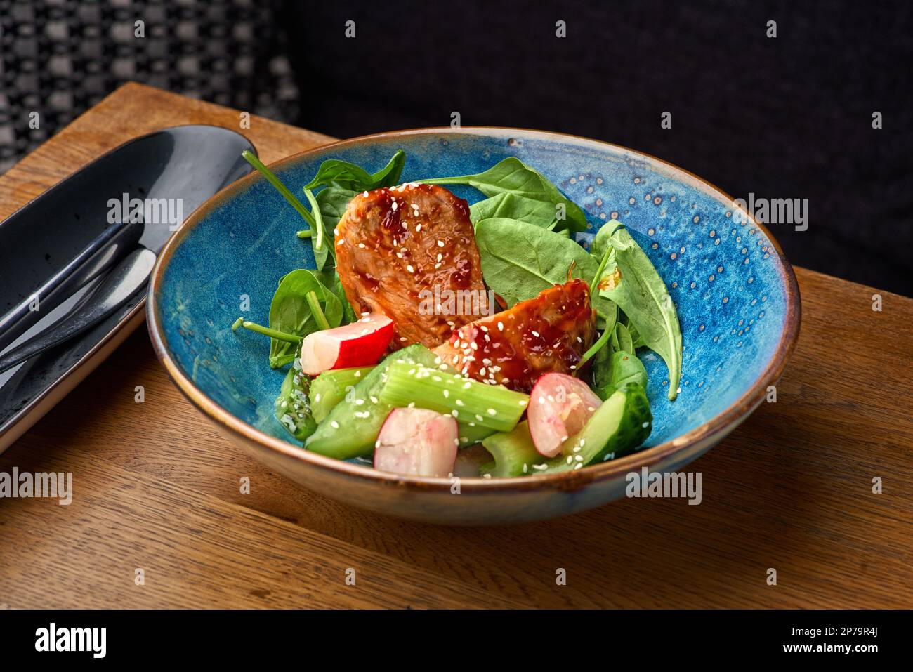 Pork tenderloin under spicy glaze and broken vegetables. Close up ...