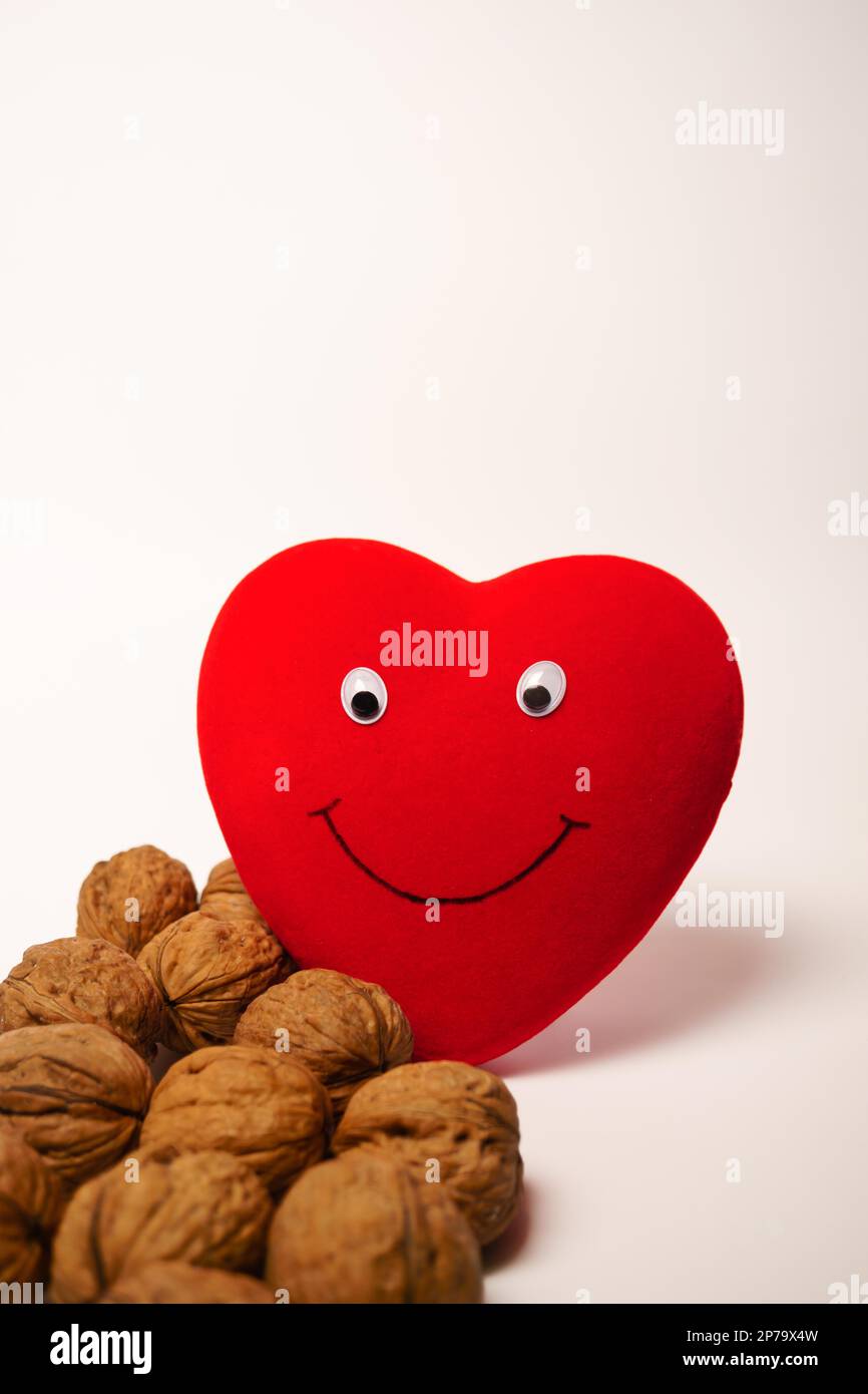 Smiling heart with nuts healthy food concept isolated on white ...
