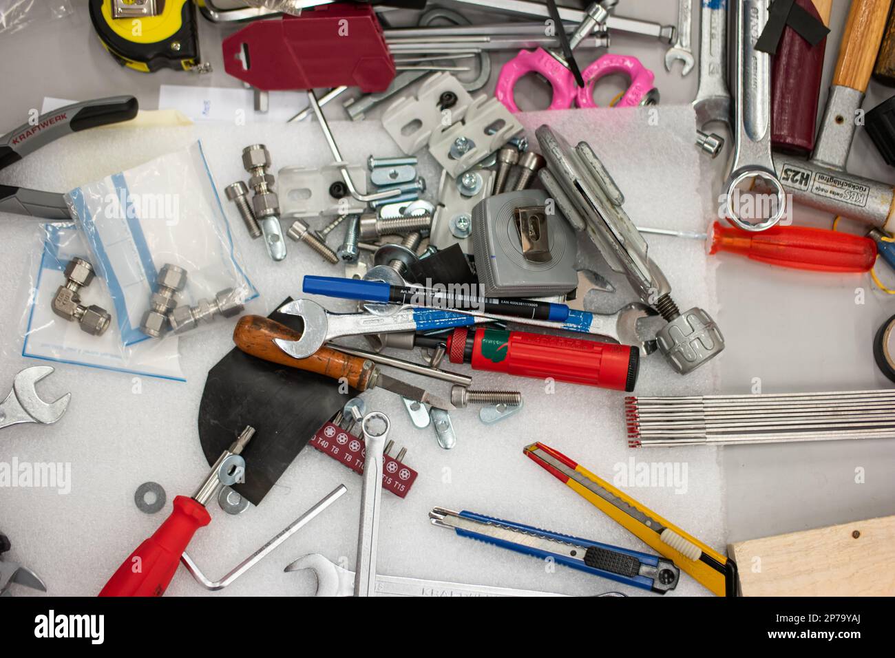 Messy tool desk top view scattered and unorganized work tools no people Stock Photo - Alamy