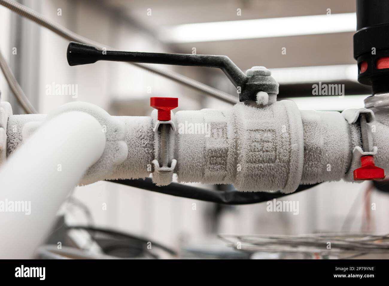 Liquid nitrogen frozen faucet lever and metal piping in a science ...