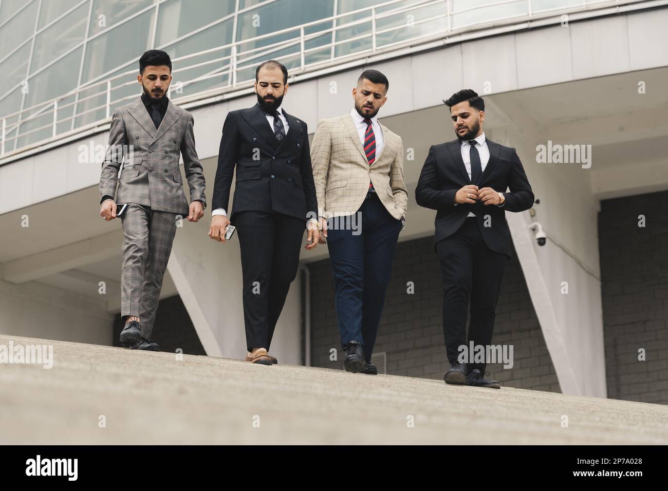 Business people outdoor meeting. A company of male businessmen in suits ...