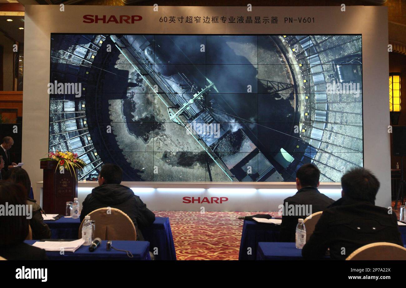 People look at a multi-screen wall with 30 60-inch Sharp PN-V601 screens in Chengdu in southwest ...