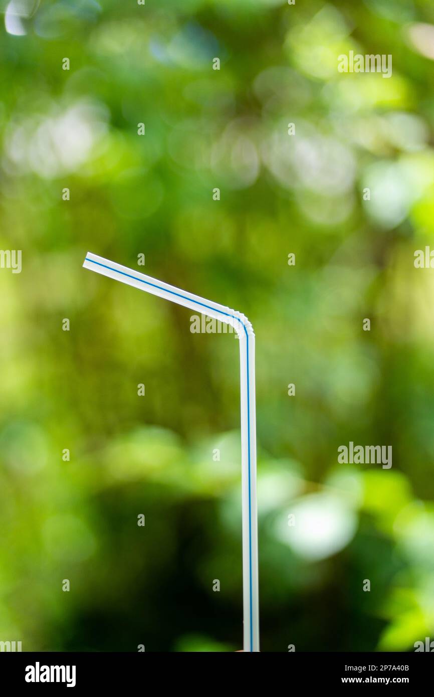 Single white and blue stripped plastic drinking straw close up shot ...