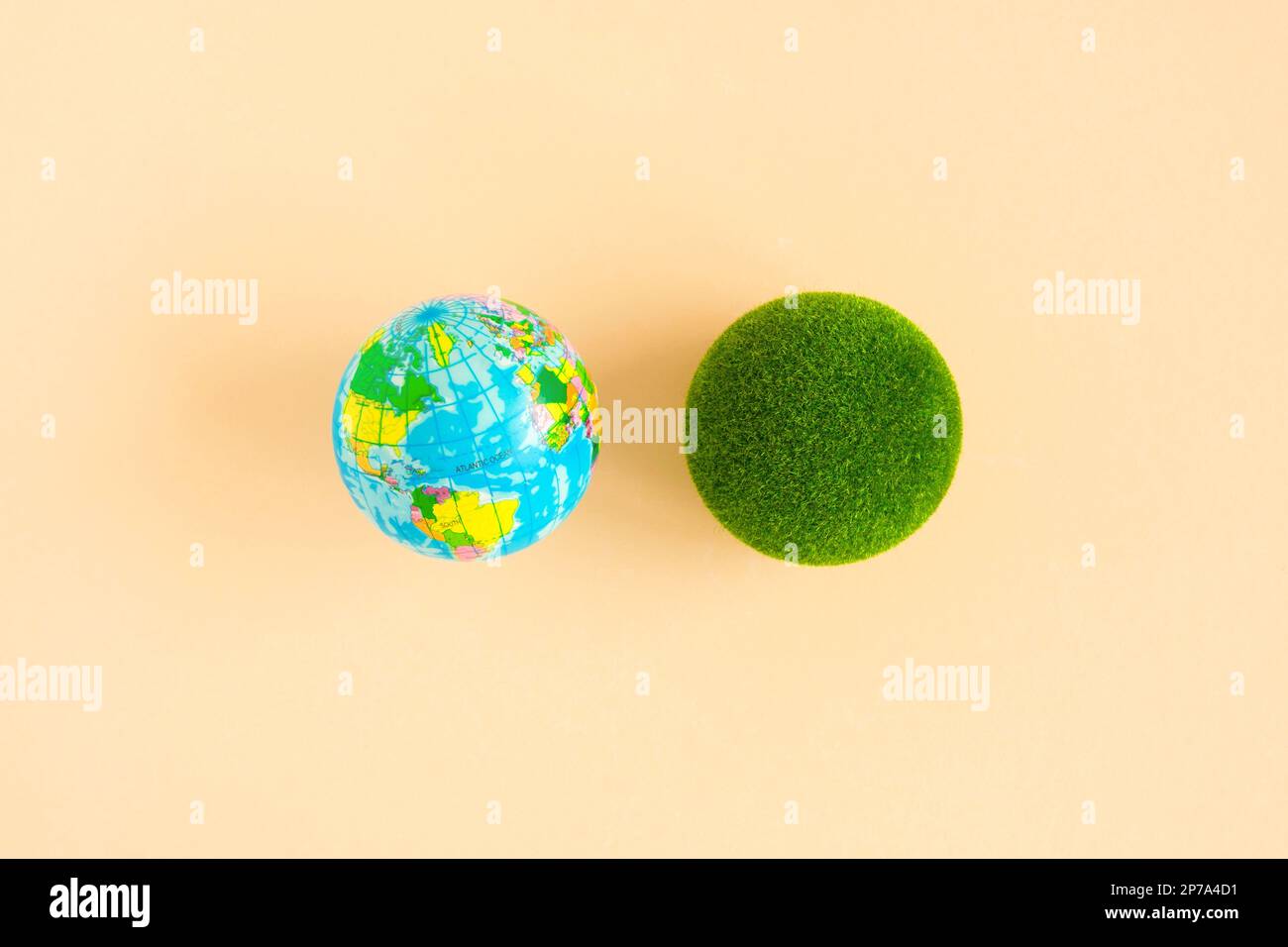 Earth day. Green planet earth and globe model on isolated beige pastel ...