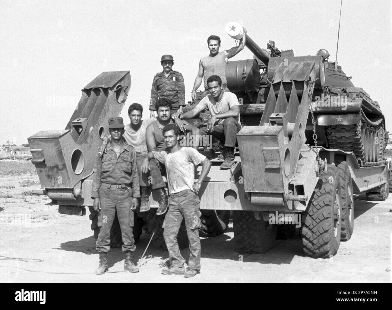 Cuban soldiers pose for pictures in front of a military vehicle during ...
