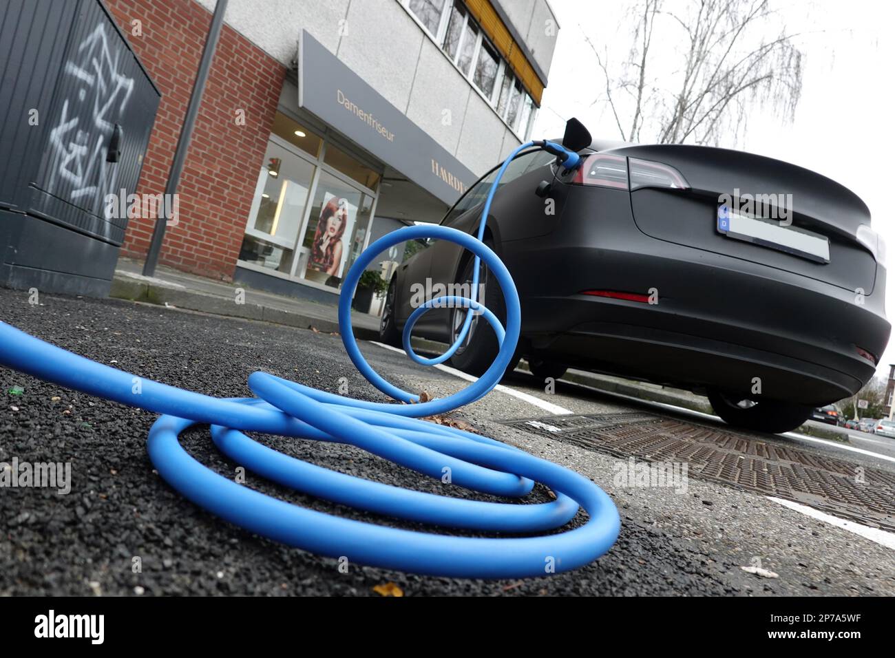 Car at an e-charging station with blue charging cable, North Rhine ...