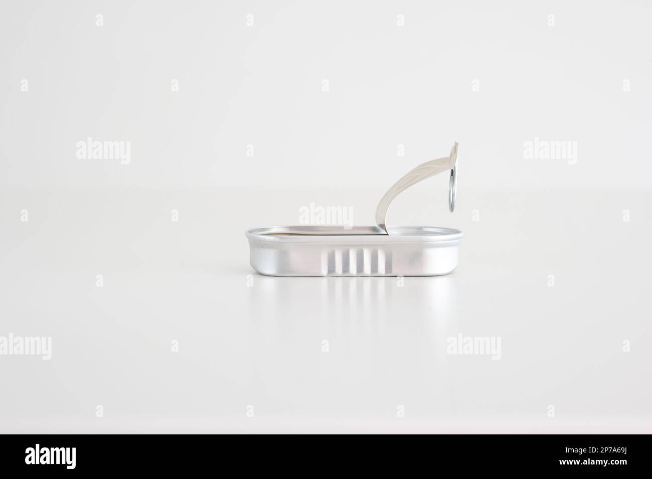 Opened empty fish tin can studio shot isolated on white front view ...