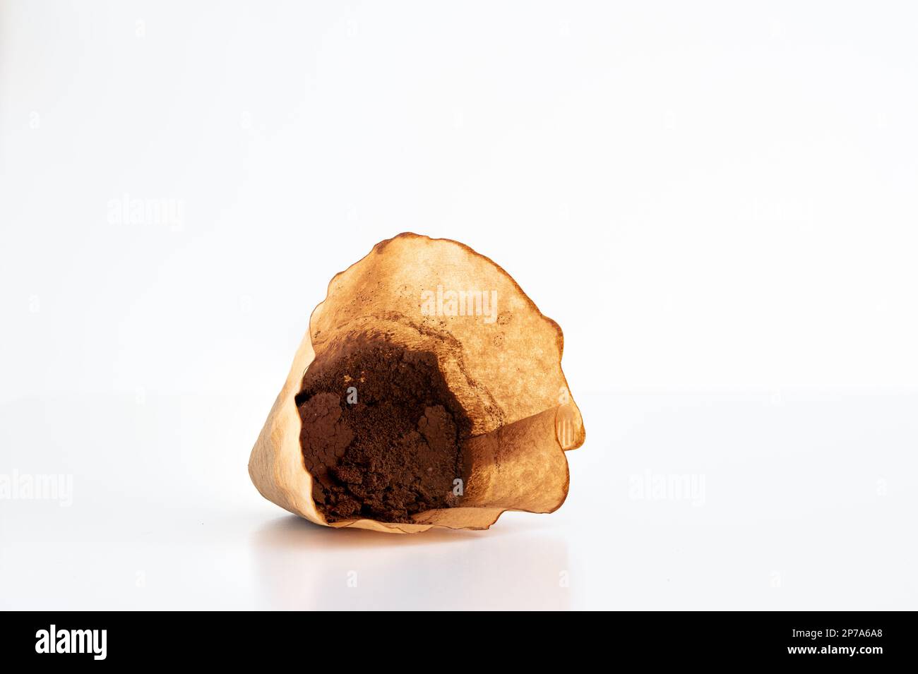 Used brown paper filter with ground coffee isolated on white Stock ...