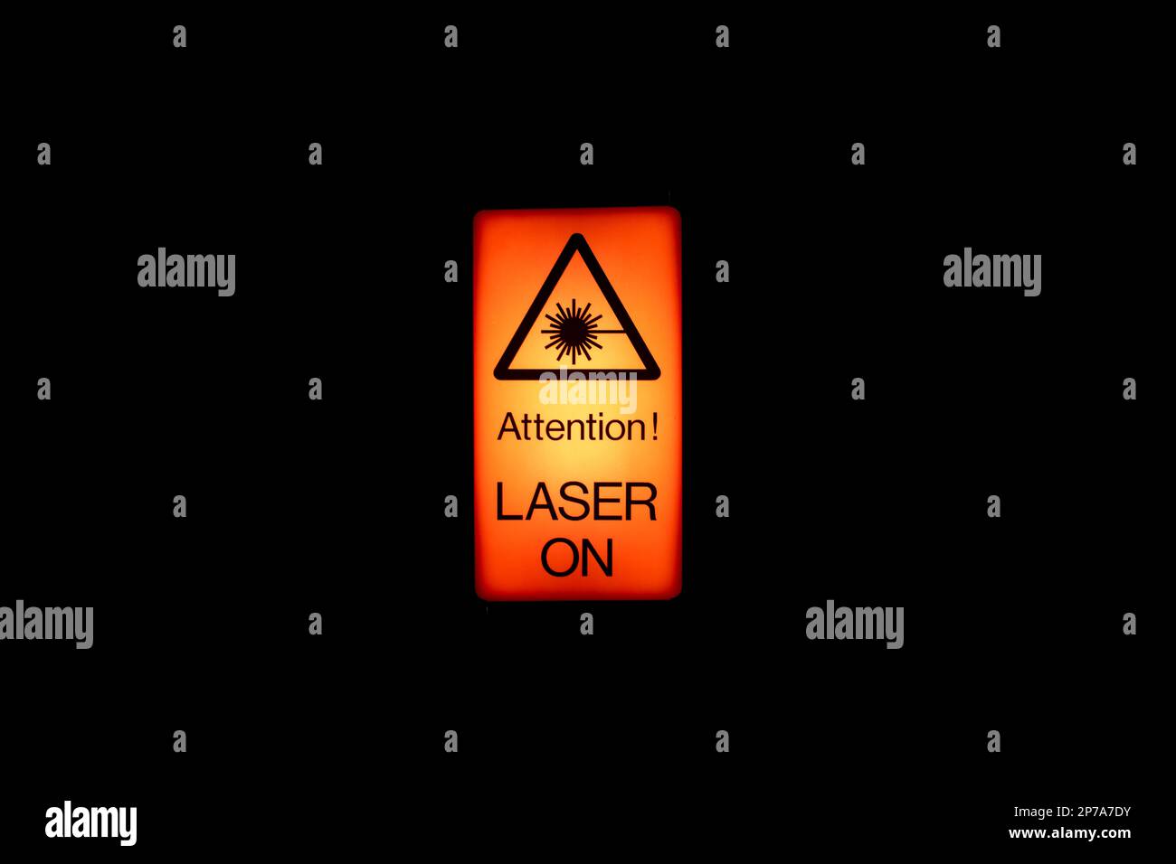 Orange glowing warning sign alerting to industrial laser room being ...