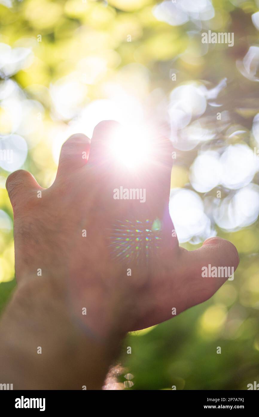 Caucasian male hand reaching upwards open hand close up shot green and ...