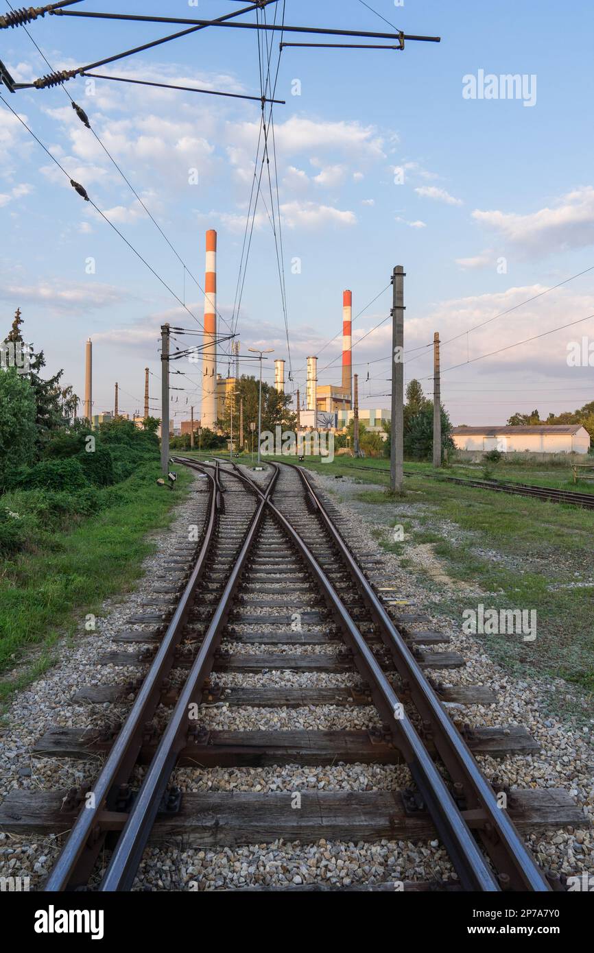 A scenic view of an industrial complex featuring multiple train tracks ...